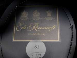 An Ede & Ravenscroft graduation gown, to include mortar board, carrying ...