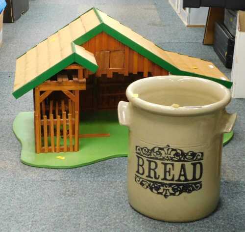 - A ceramic bread bin and a scratch-built model house. (2)