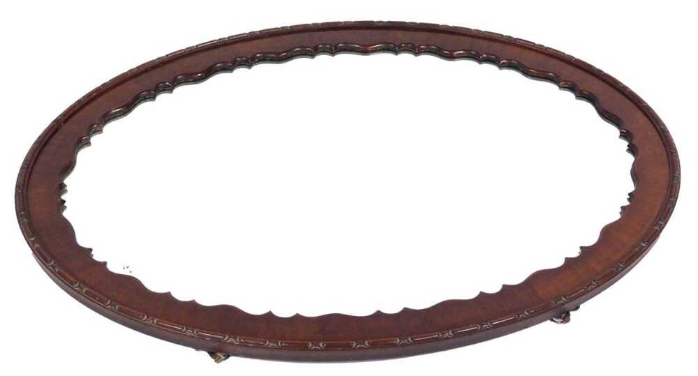 An early 20thC mahogany oval framed wall mirror, 90cm high, 67cm wide.
