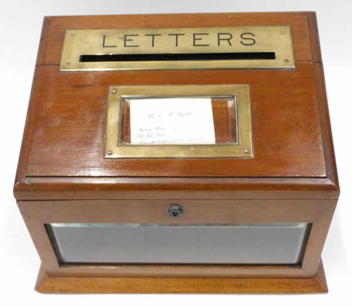 An Edwardian mahogany and brass mounted letter box, the sloping top ...
